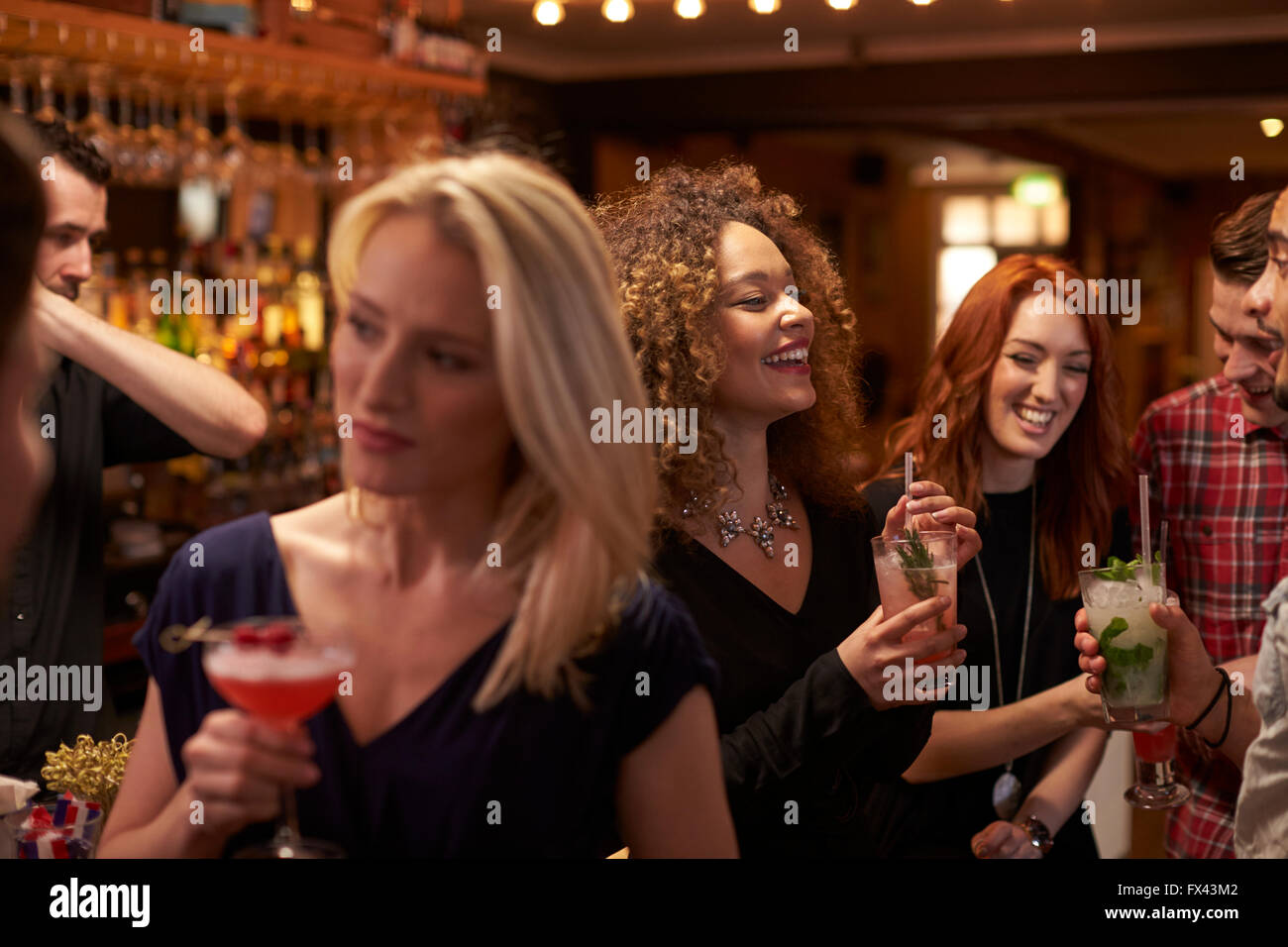 Group Of Friends Meeting For Evening Drinks In Cocktail Bar Stock Photo ...