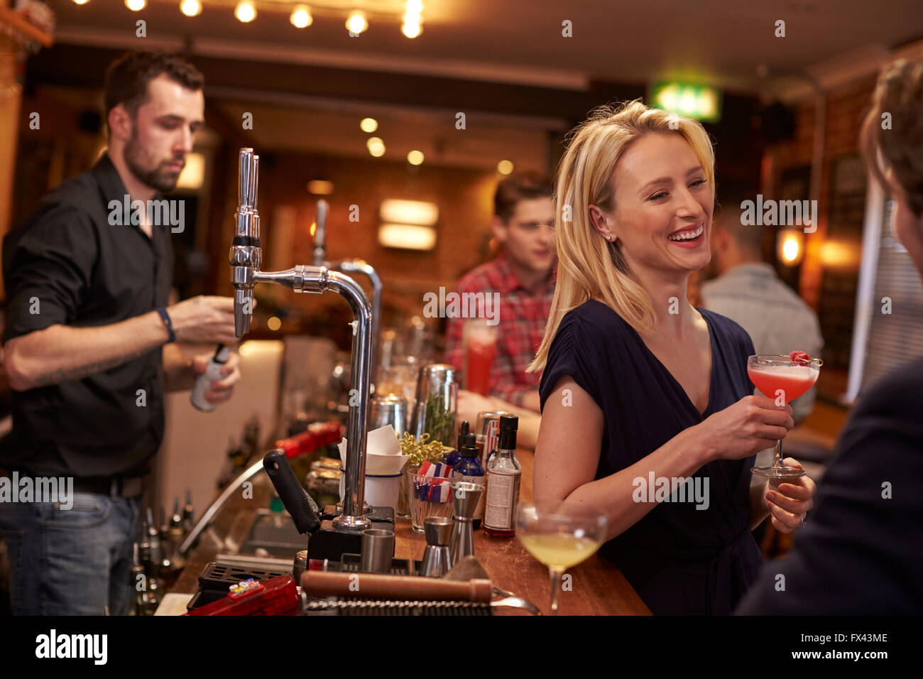 Group Of Friends Meeting For Evening Drinks In Cocktail Bar Stock Photo ...