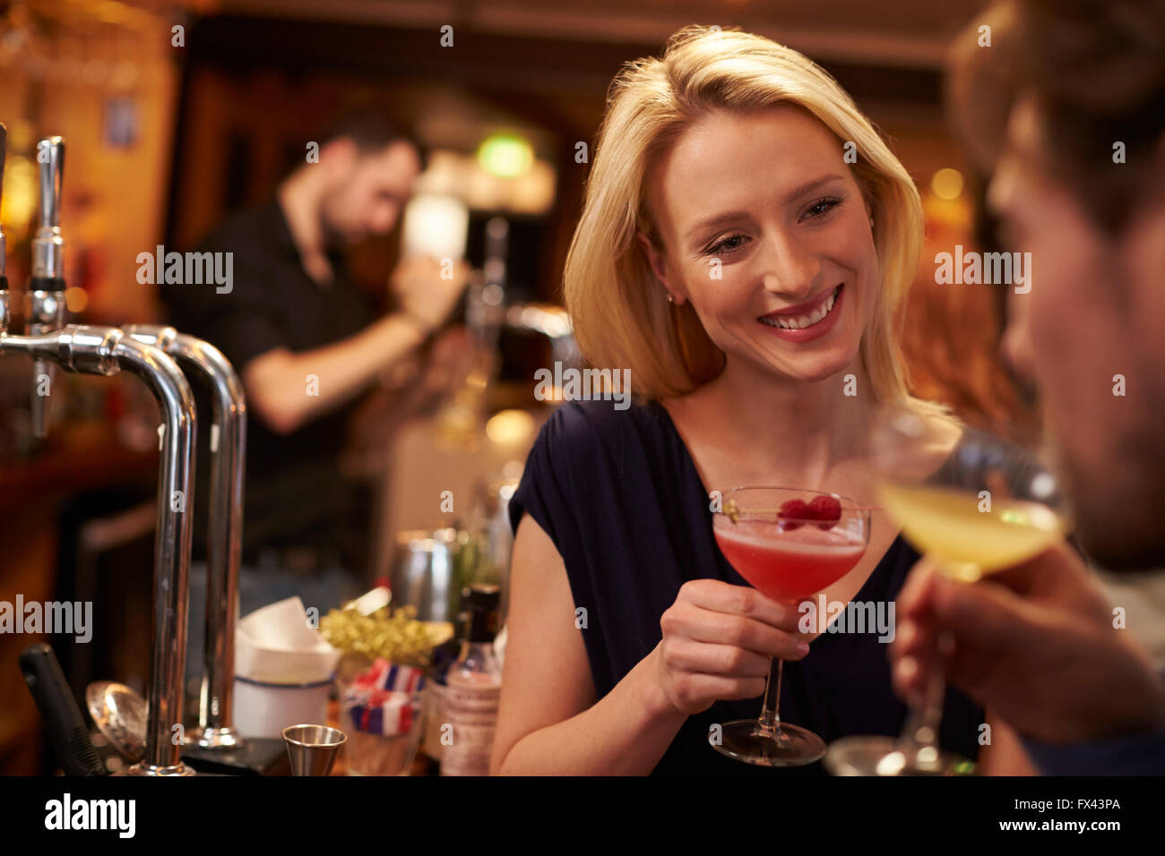 Couple Meeting For Evening Drinks In Cocktail Bar Stock Photo - Alamy