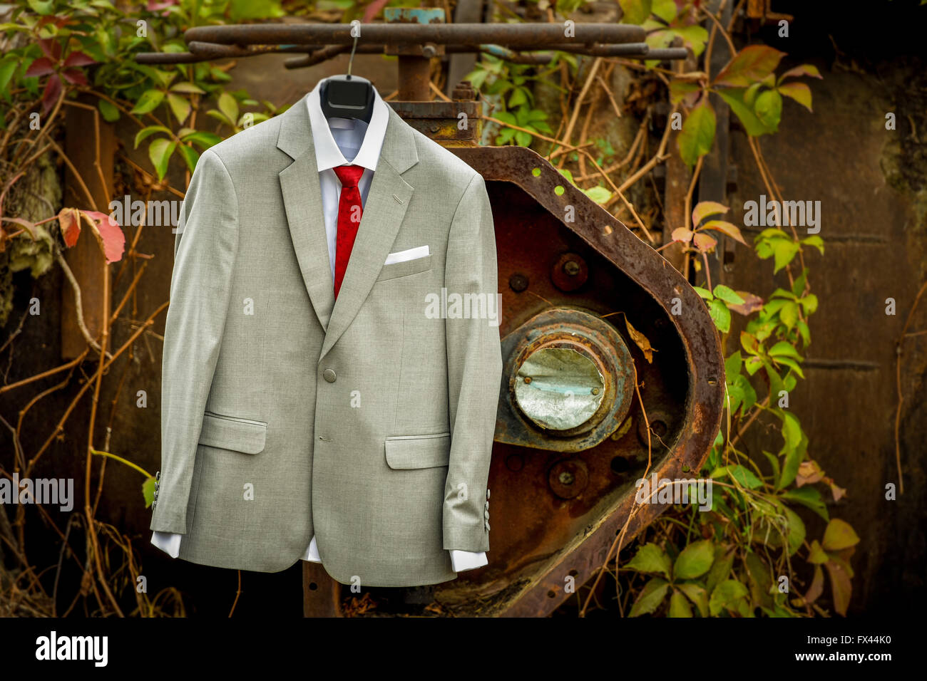 Gray groom suit next to old rusty machinery Stock Photo - Alamy