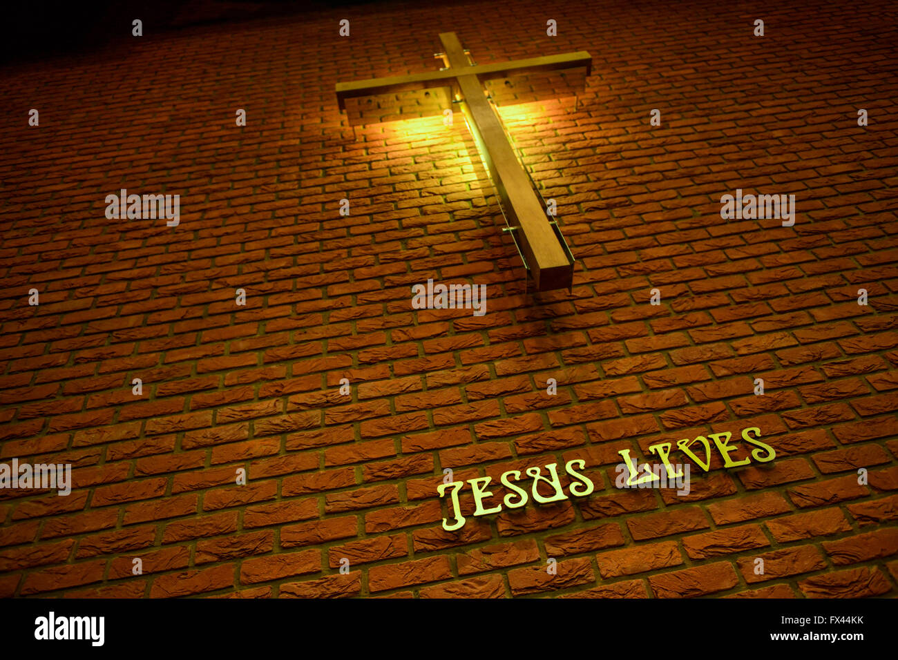 Cross and wrote Jesus Lives on a brick wall Stock Photo - Alamy