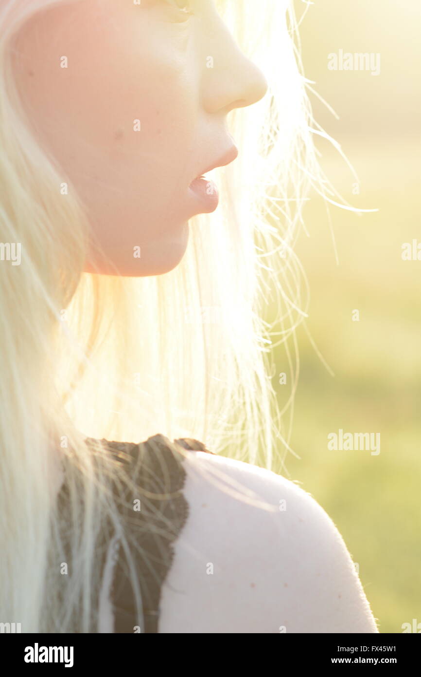 A beautiful young woman backlit by morning sun Stock Photo - Alamy
