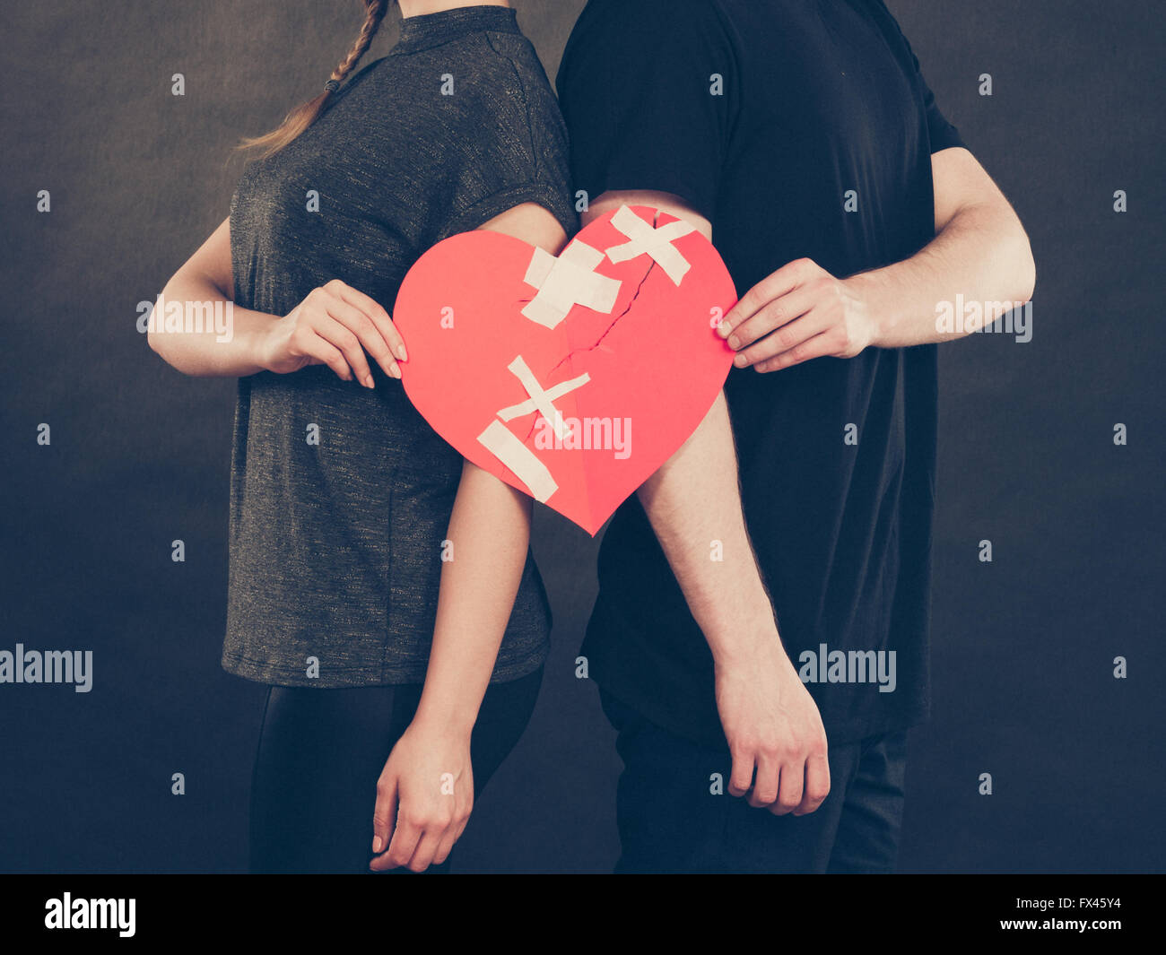 Broken heart difficult love concept. Couple woman and man hands holding ...