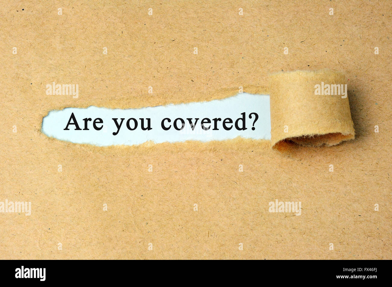 Are you covered? word written under torn brown paper Stock Photo - Alamy