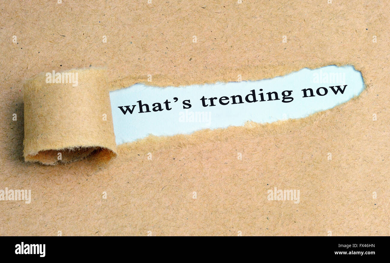 What's trending now text under torn paper Stock Photo - Alamy