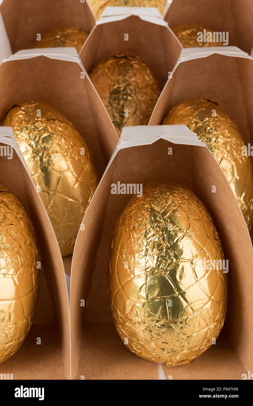 over indulgence in chocolate Easter eggs wrapped up in shiny gold foil ...