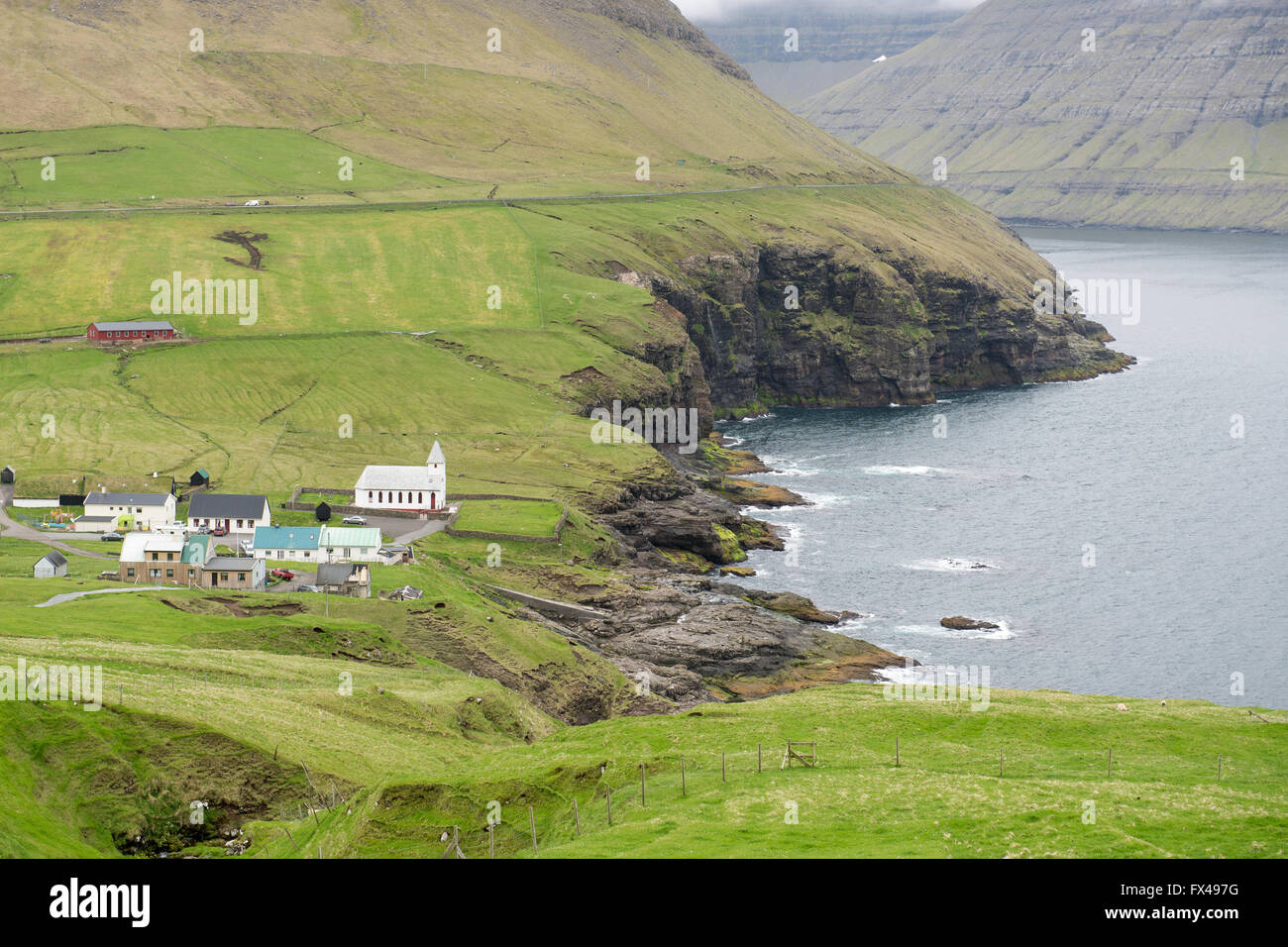 Typical landscape on the Faroe Islands, with green grass, rocks and ...