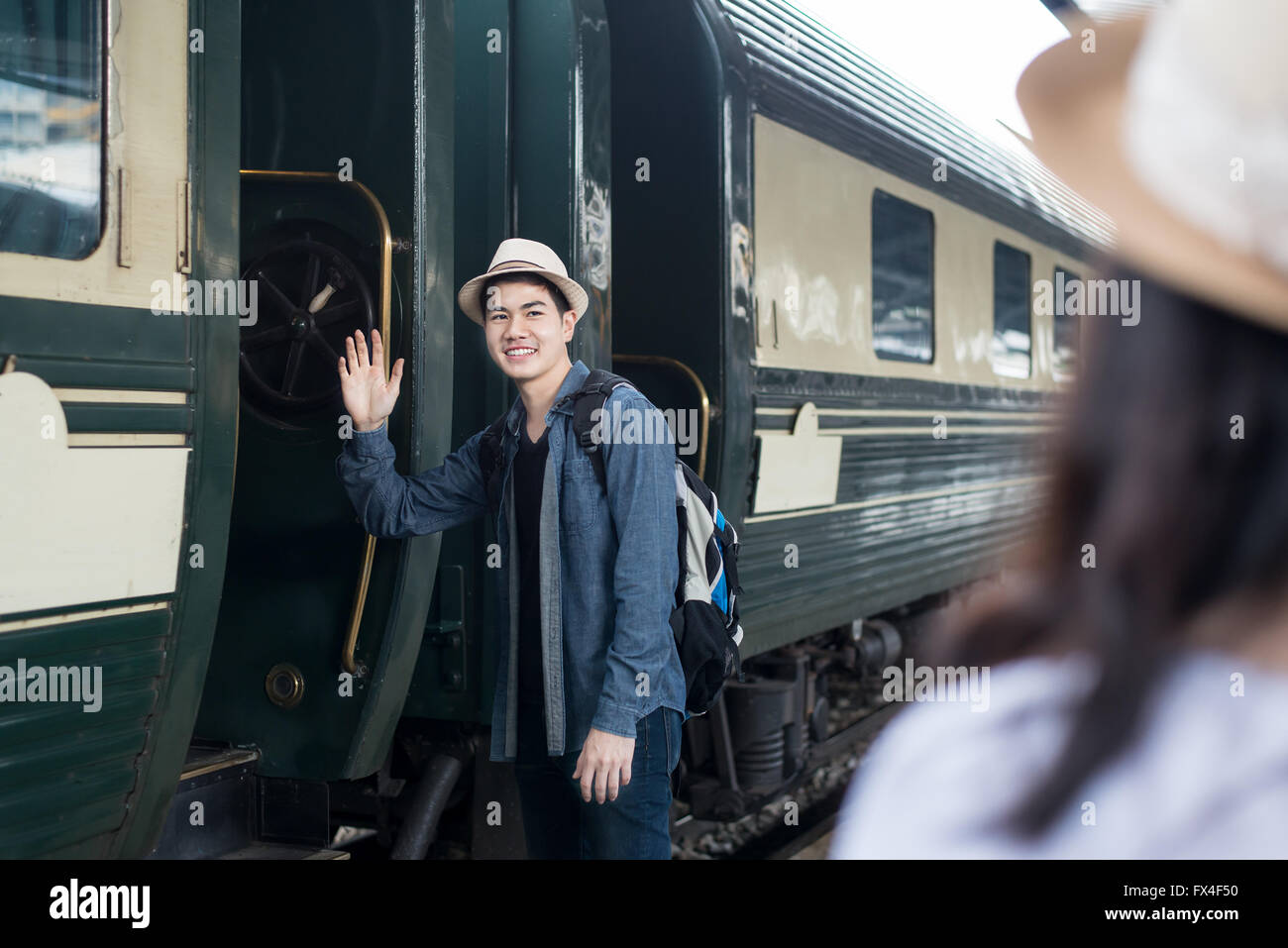 Handsome Young Asian man say goodbye to girlfriend at train station ...