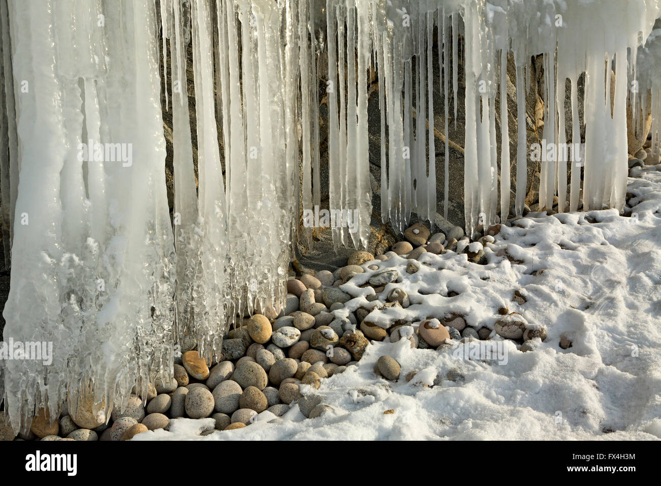 Huge icicles on rocks Stock Photo - Alamy
