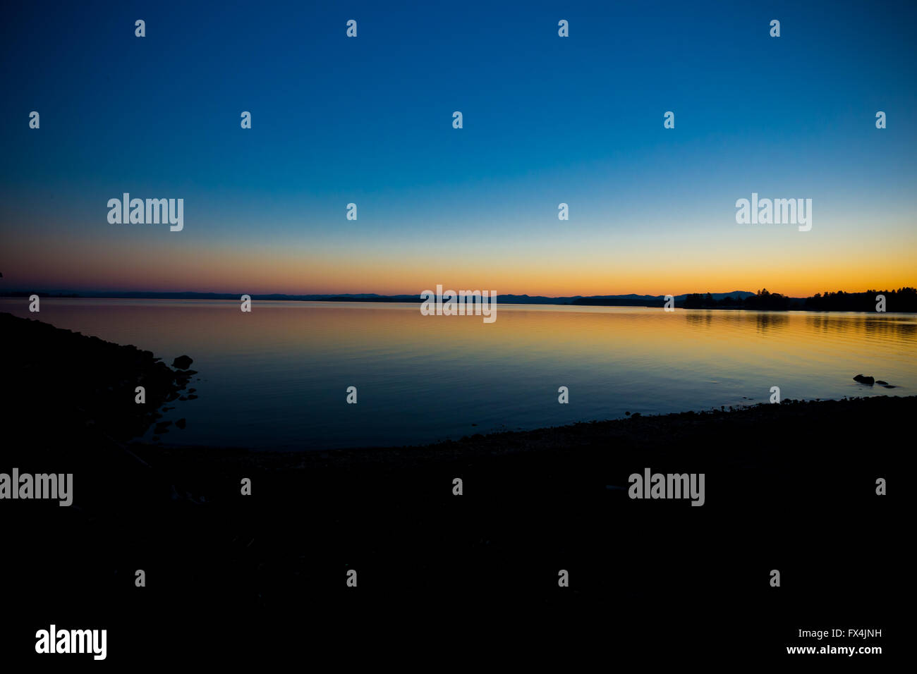 This beautiful sunset over water is photographed in an abstract way to ...