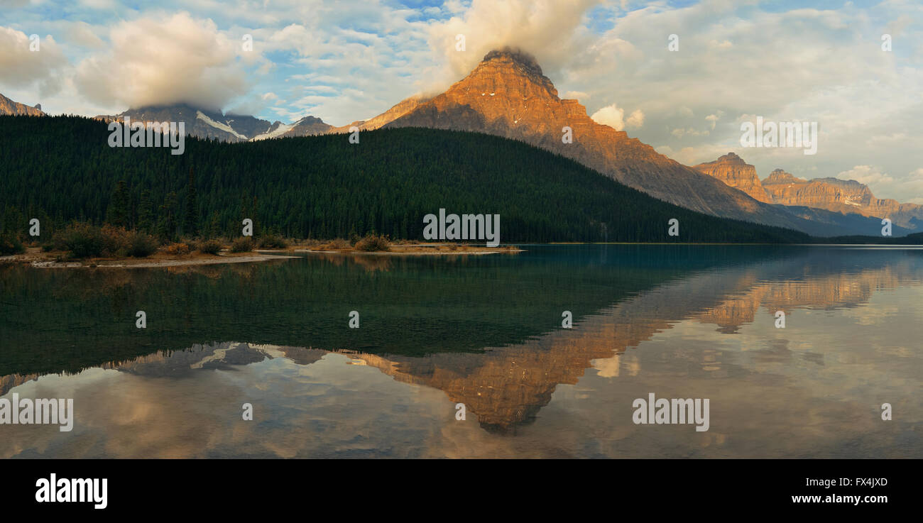 Lake at sunrise with cloud and mountain reflections in Banff National ...