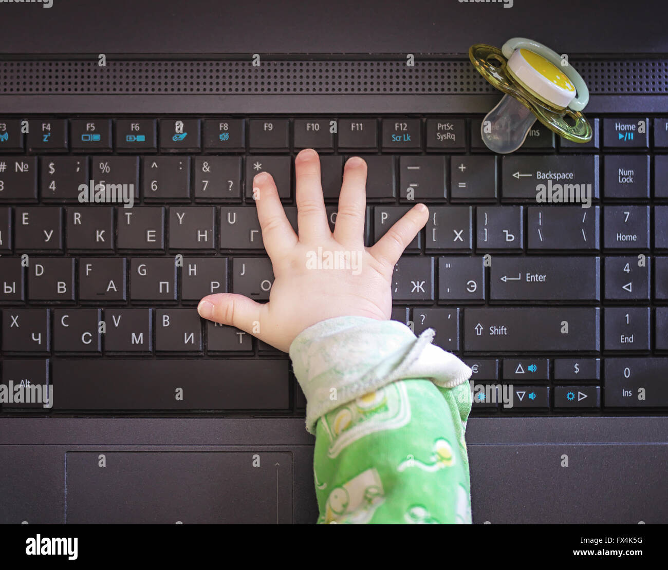 Child hand and computer. Conceptual scene Stock Photo - Alamy