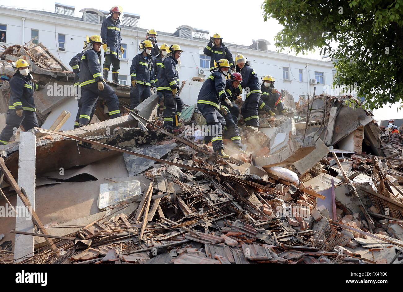 Shanghai. 11th Apr, 2016. Rescuers search for trapped people at the ...