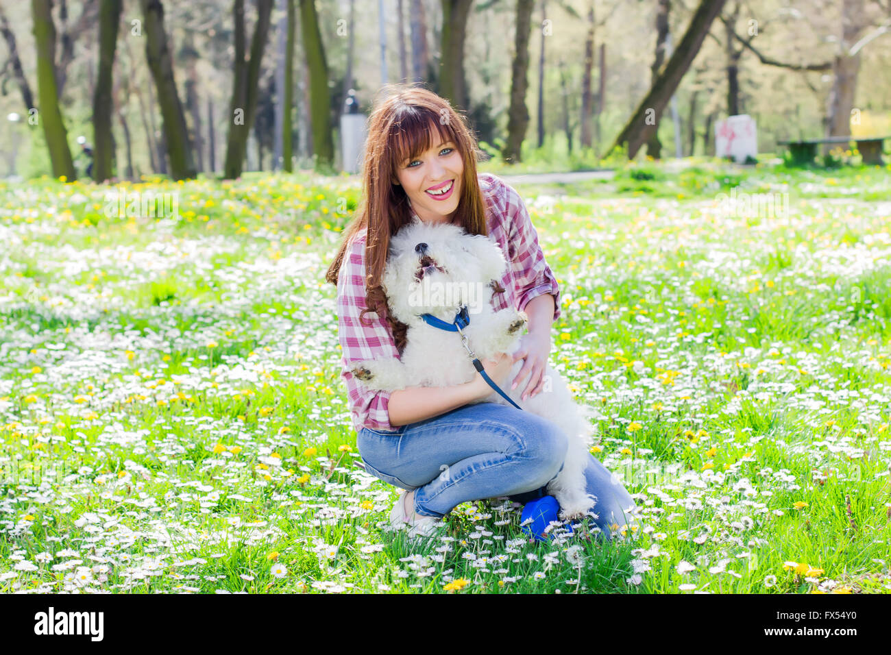 Happy beautiful young woman, enjoying nature with her dog, at sunny ...