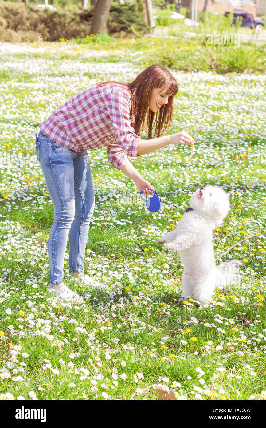 Happy beautiful young woman, enjoying nature with her dog, at sunny ...
