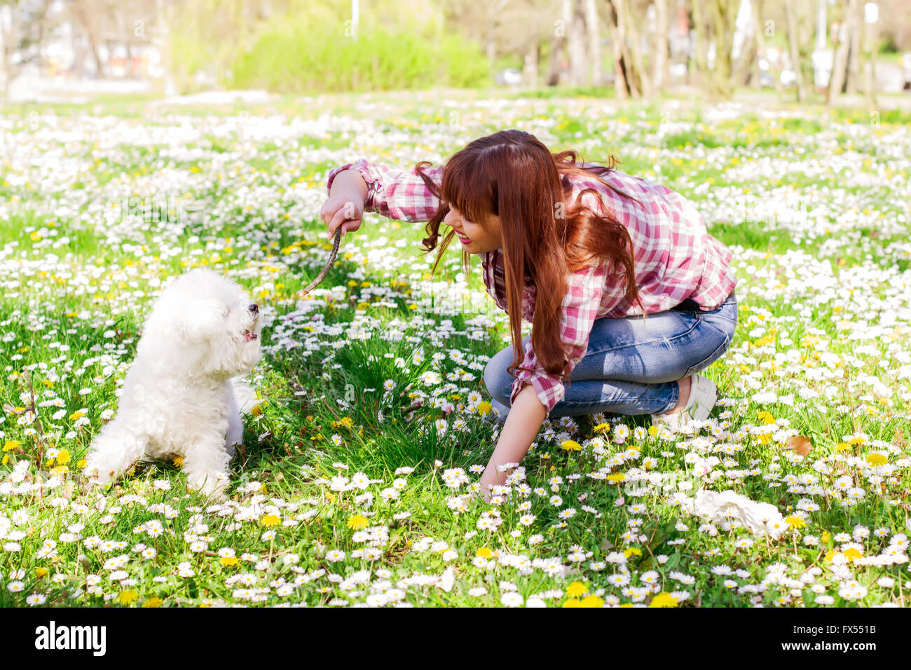 Happy beautiful young woman, enjoying nature with her dog, at sunny ...