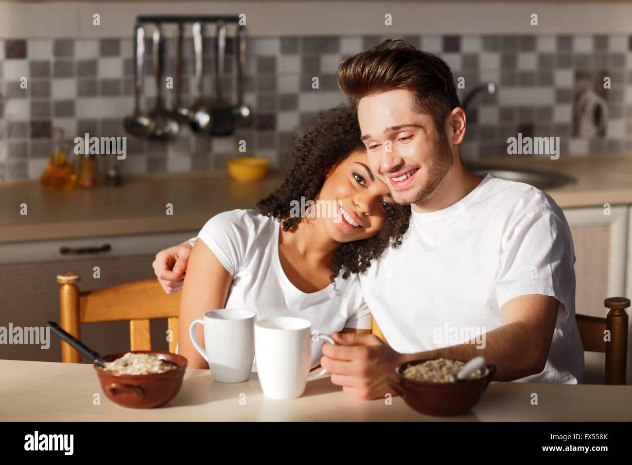 Happy couple having breakfast together Stock Photo - Alamy