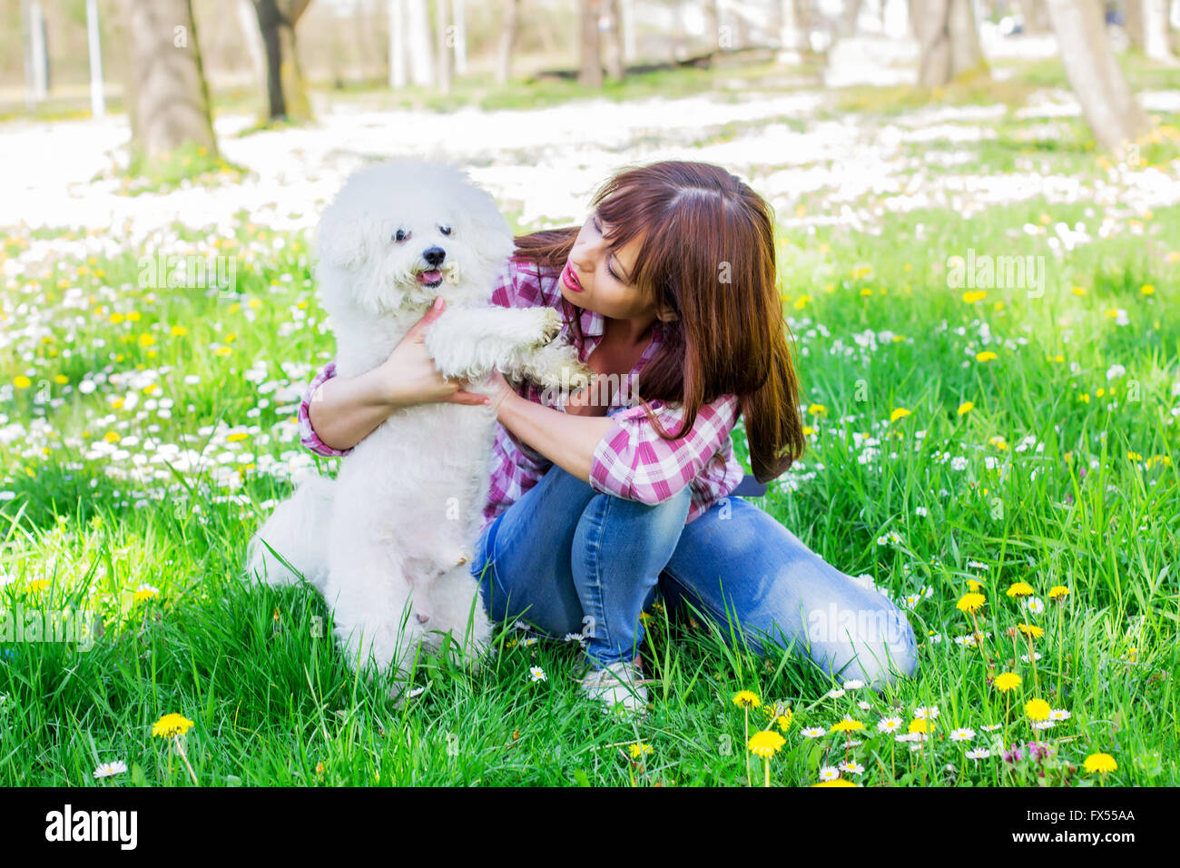 Happy beautiful young woman, enjoying nature with her dog, at sunny ...