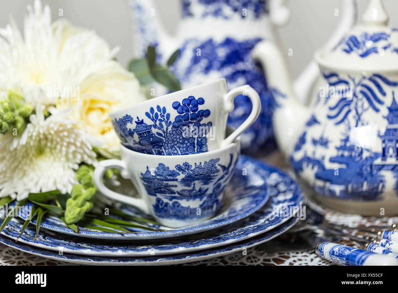 Blue and white transferware Spode willow pattern tea set on lace cloth ...