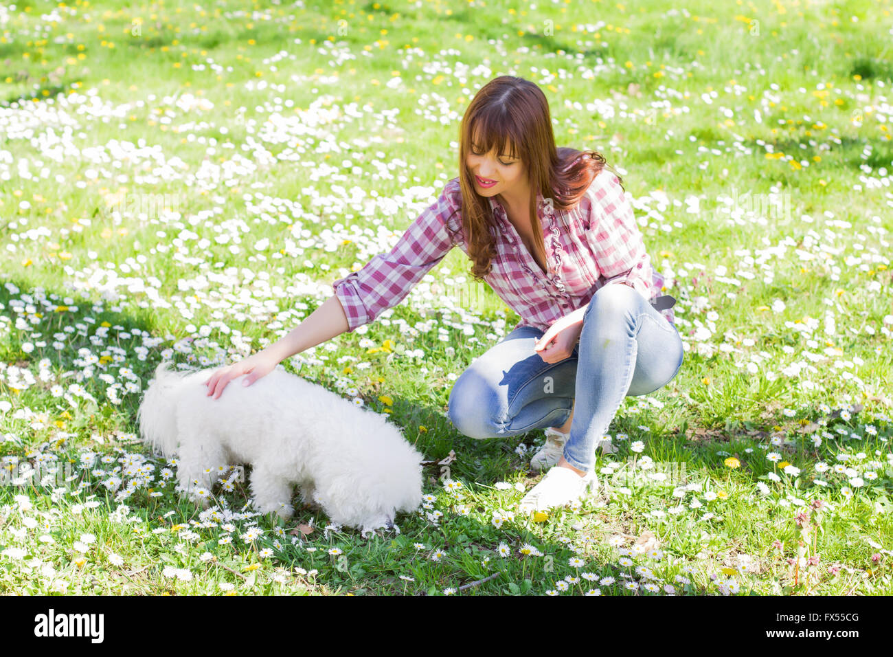 Happy beautiful young woman, enjoying nature with her dog, at sunny ...