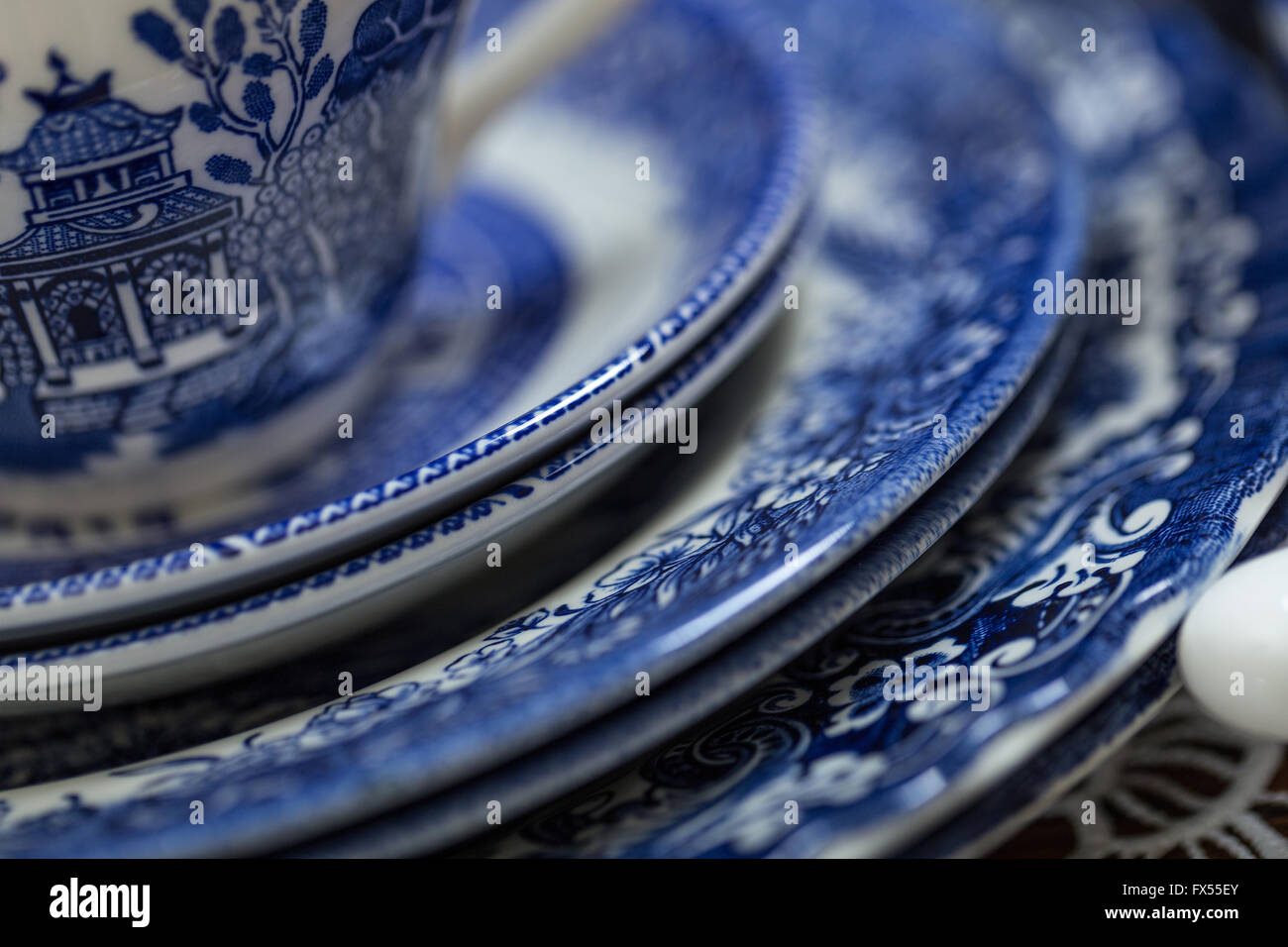 Blue and white transferware Spode willow pattern tea set on lace cloth ...