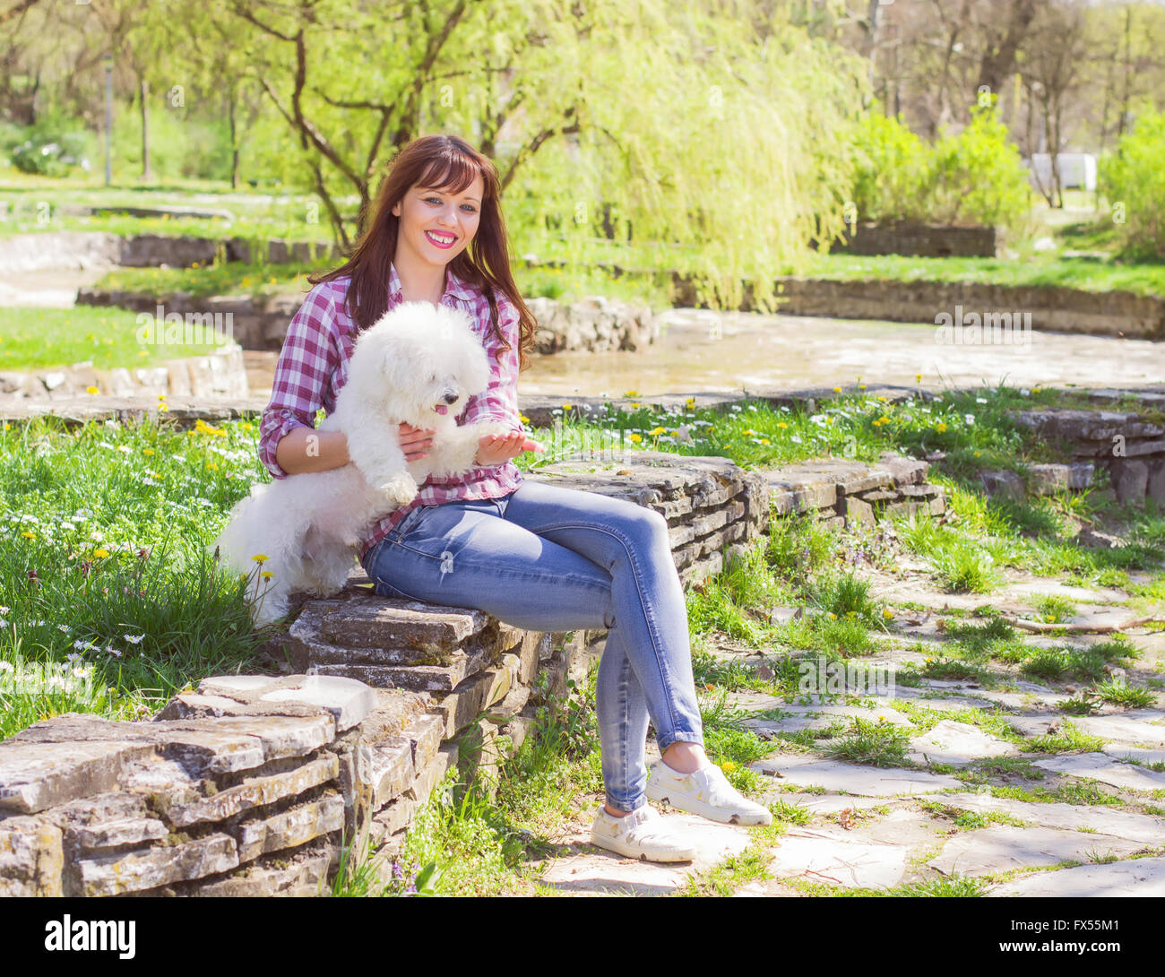 Happy beautiful young woman, enjoying nature with her dog, at sunny ...