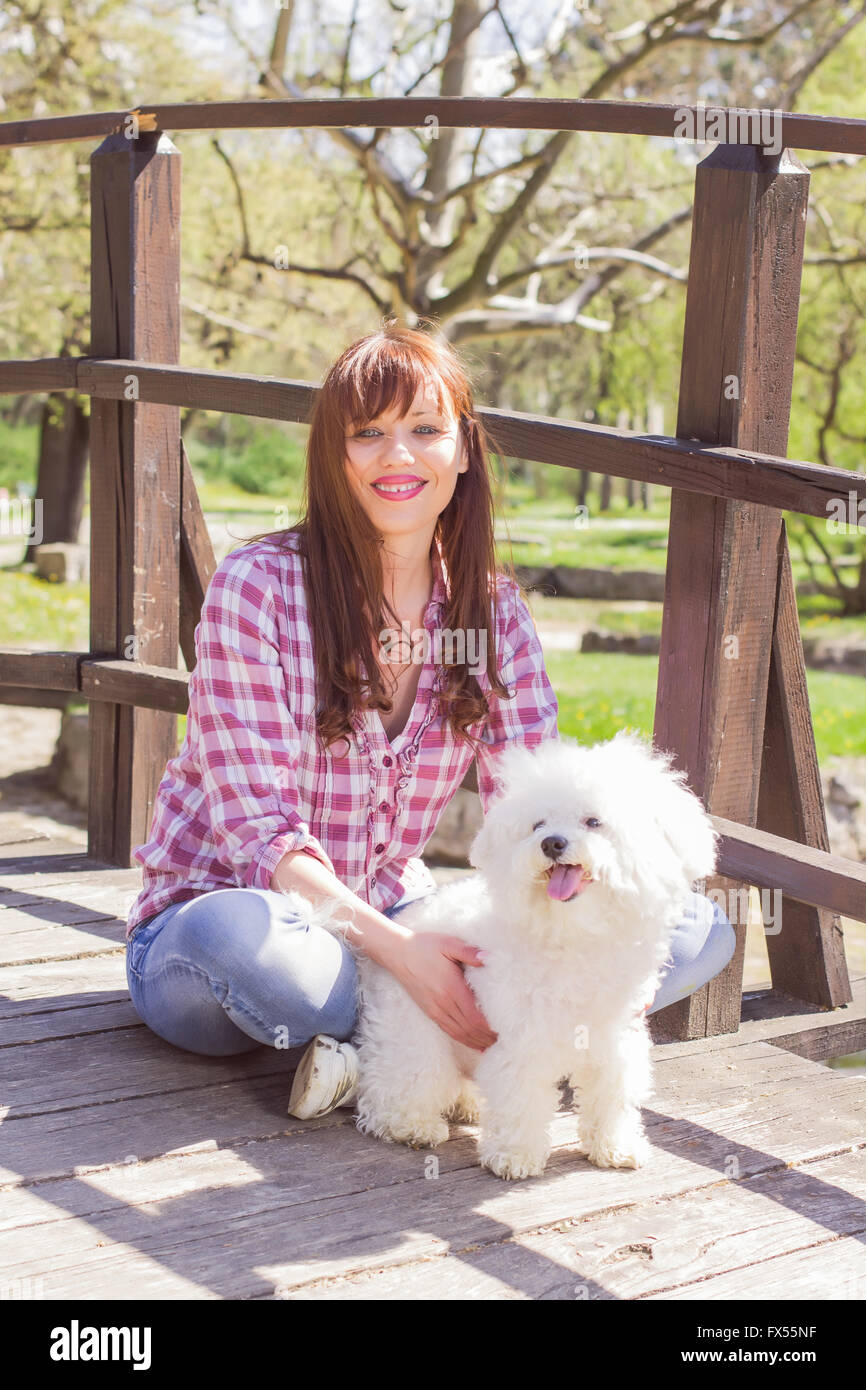 Happy beautiful young woman, enjoying nature with her dog, at sunny ...