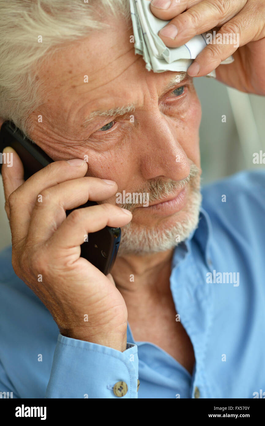 Sick old man calling doctor Stock Photo - Alamy