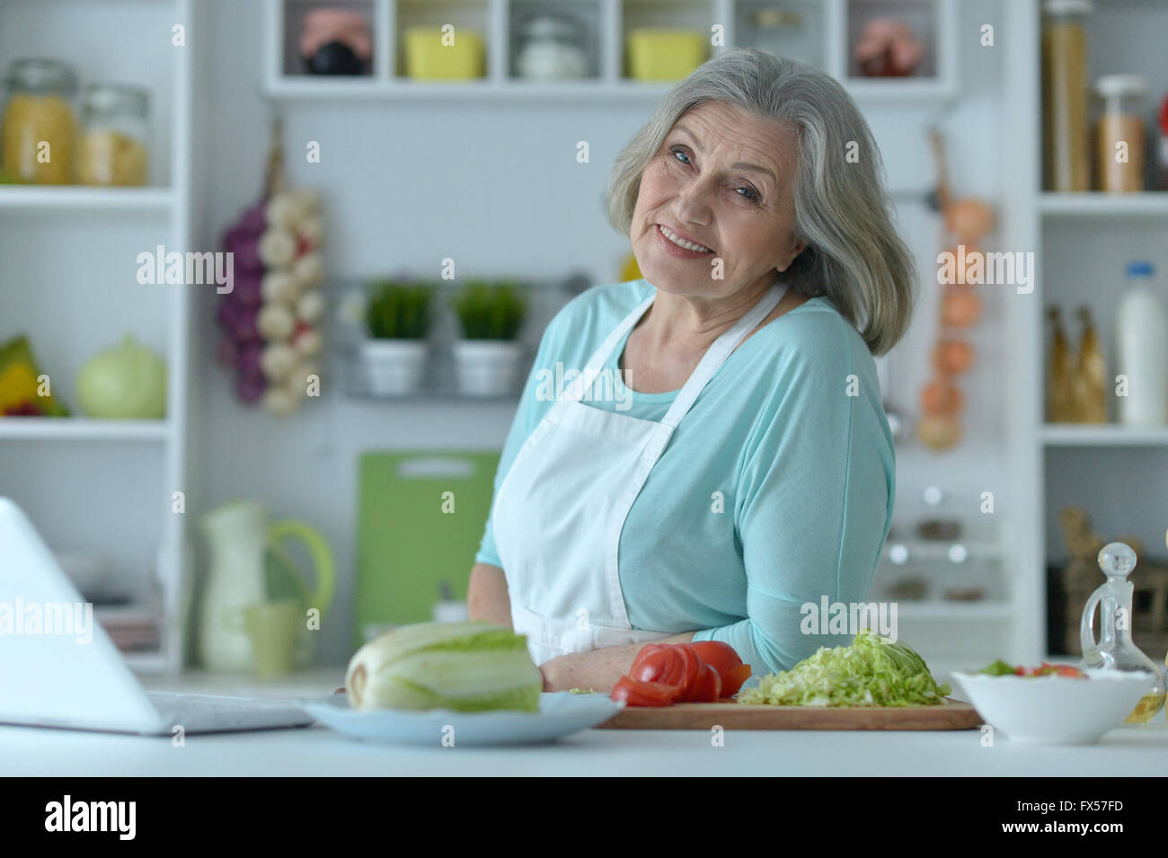 Senior woman cooking in kitchen Stock Photo - Alamy