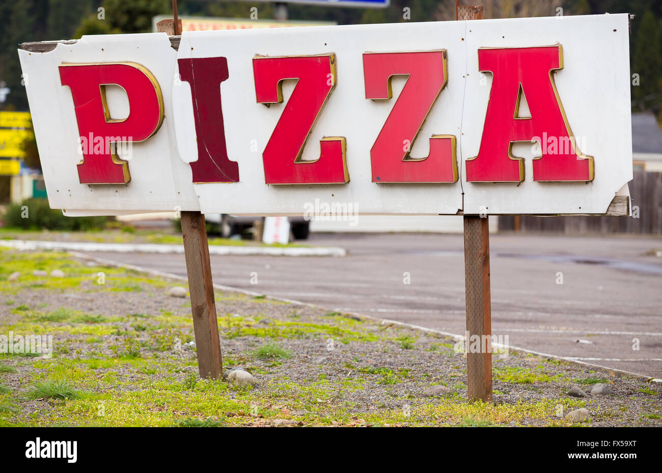 Weathered pizza restaurant sign with red and green Stock Photo - Alamy