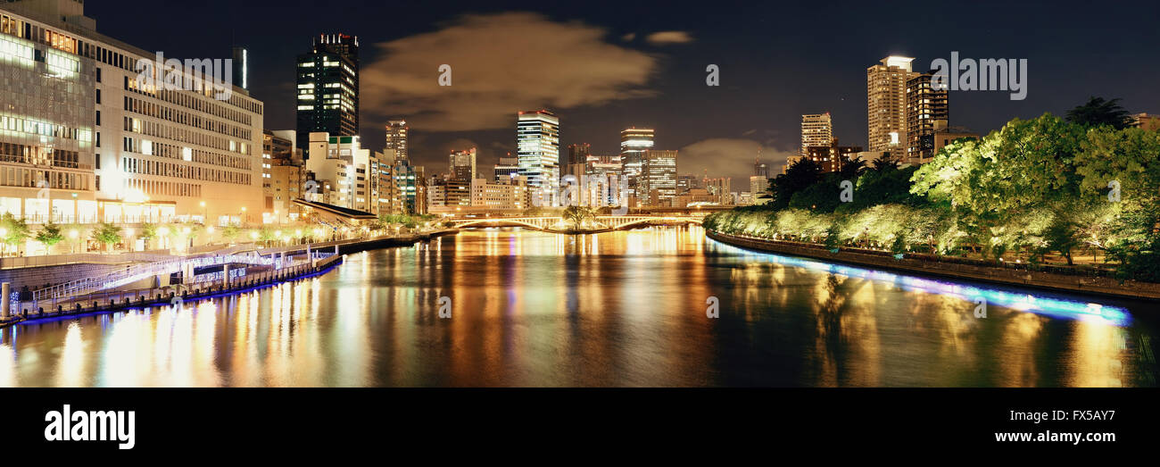 Osaka skyline over river with skyscrapers and bridge. Japan Stock Photo ...