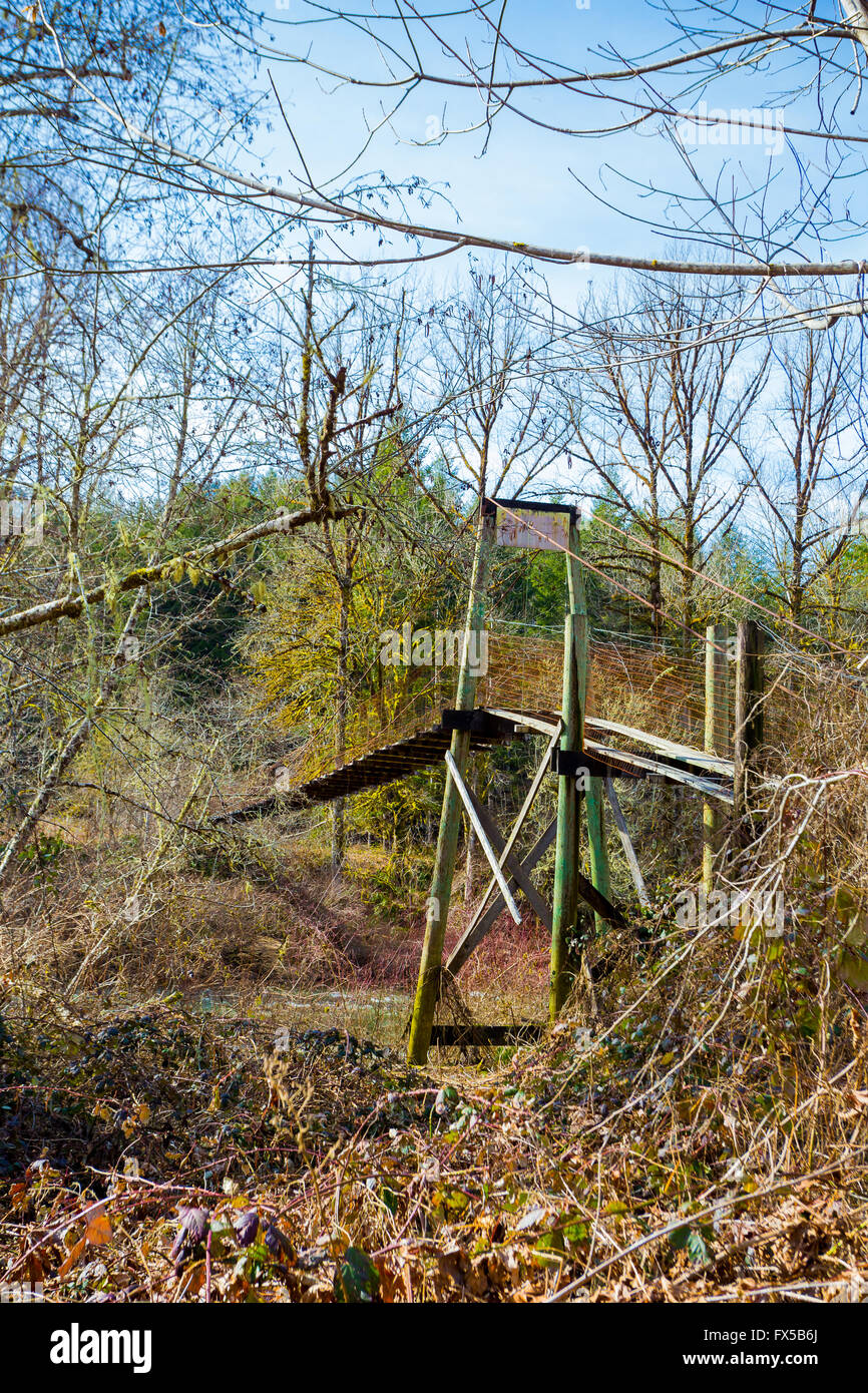 Very old swinging bridge crosses the Siuslaw River near Mapleton Oregon ...