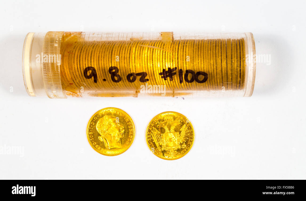 Gold coins in a tube and displayed front and back on white Stock Photo ...