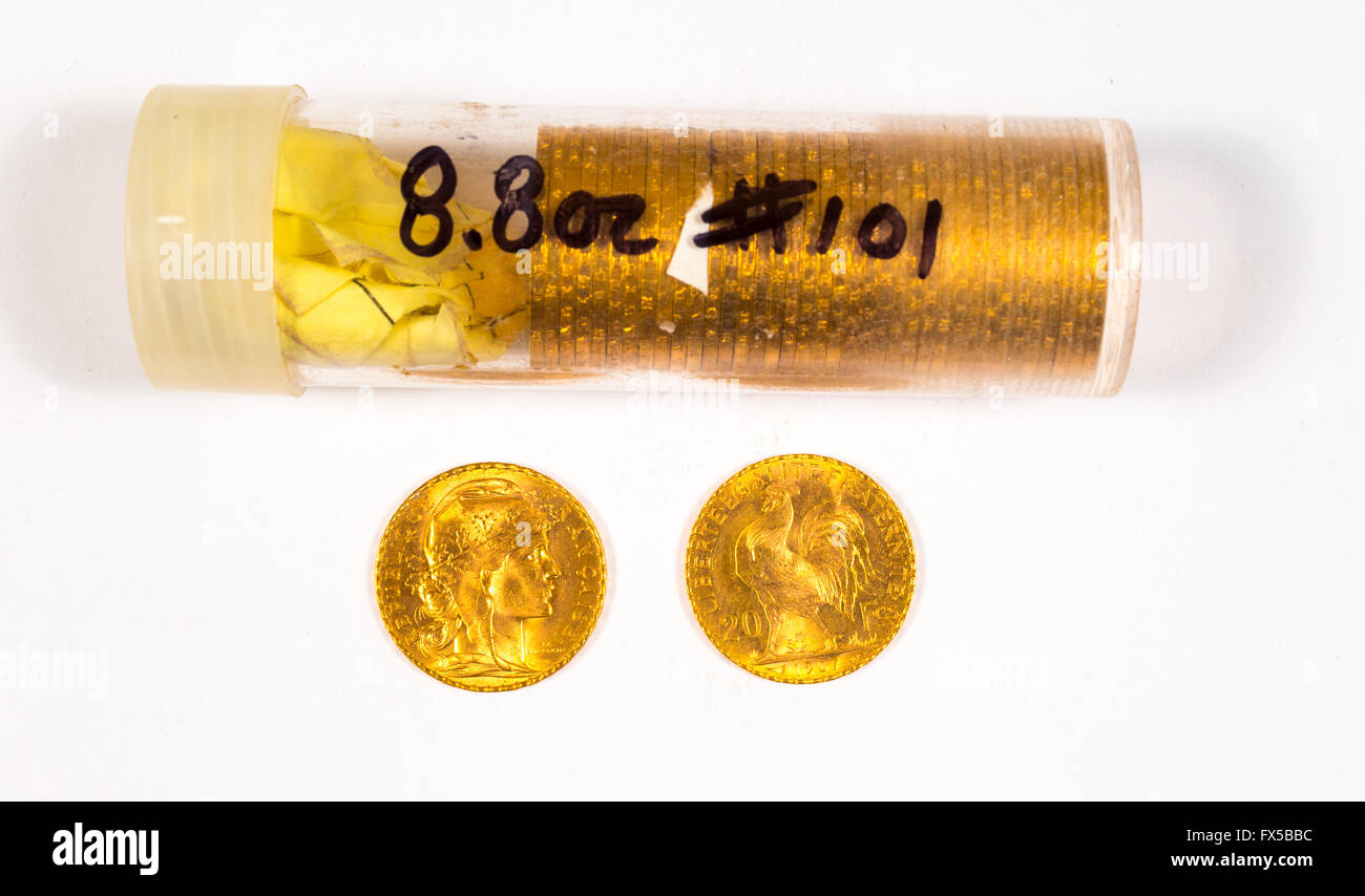 Gold coins in a tube and displayed front and back on white Stock Photo ...