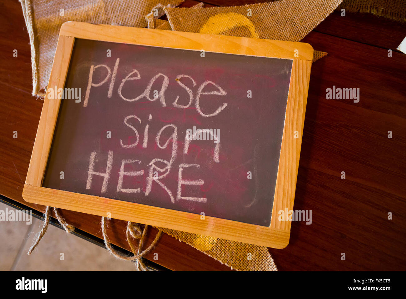 Please sign here written in chalk on a guestbook table sign Stock Photo ...