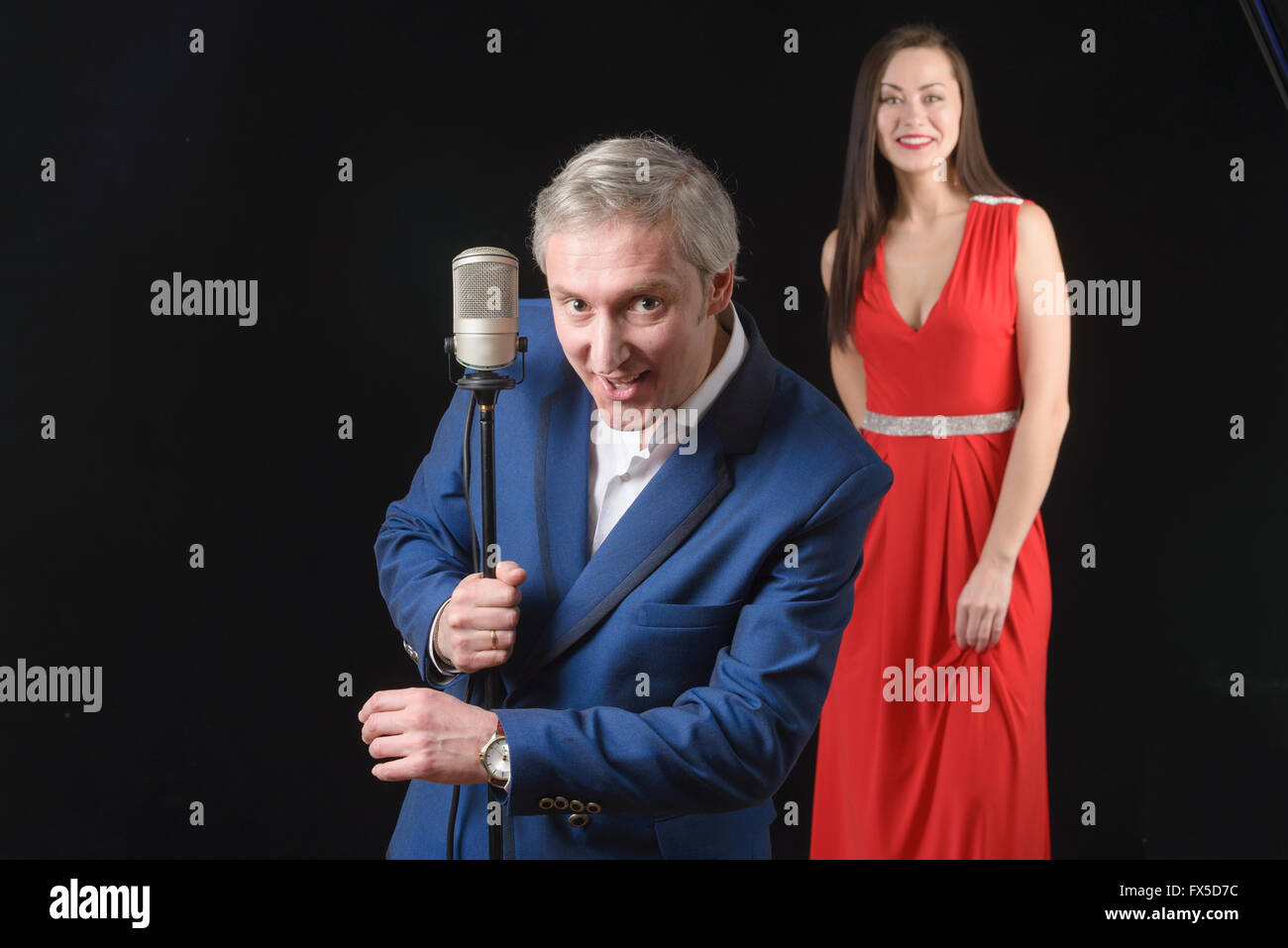 hoary senior singer singing with back vocal girls. UnRetouched image ...