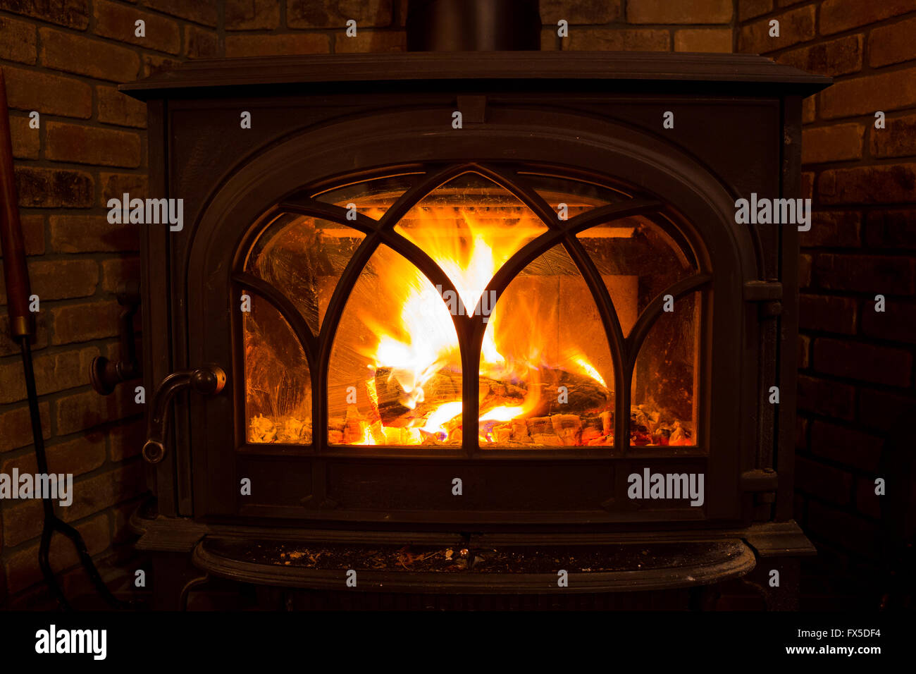 Fire burning in a wood stove at a lodge cabin Stock Photo - Alamy
