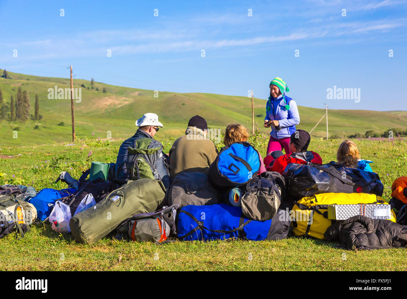 Group of People and Many Backpacks on Grassy Lawn Stock Photo - Alamy