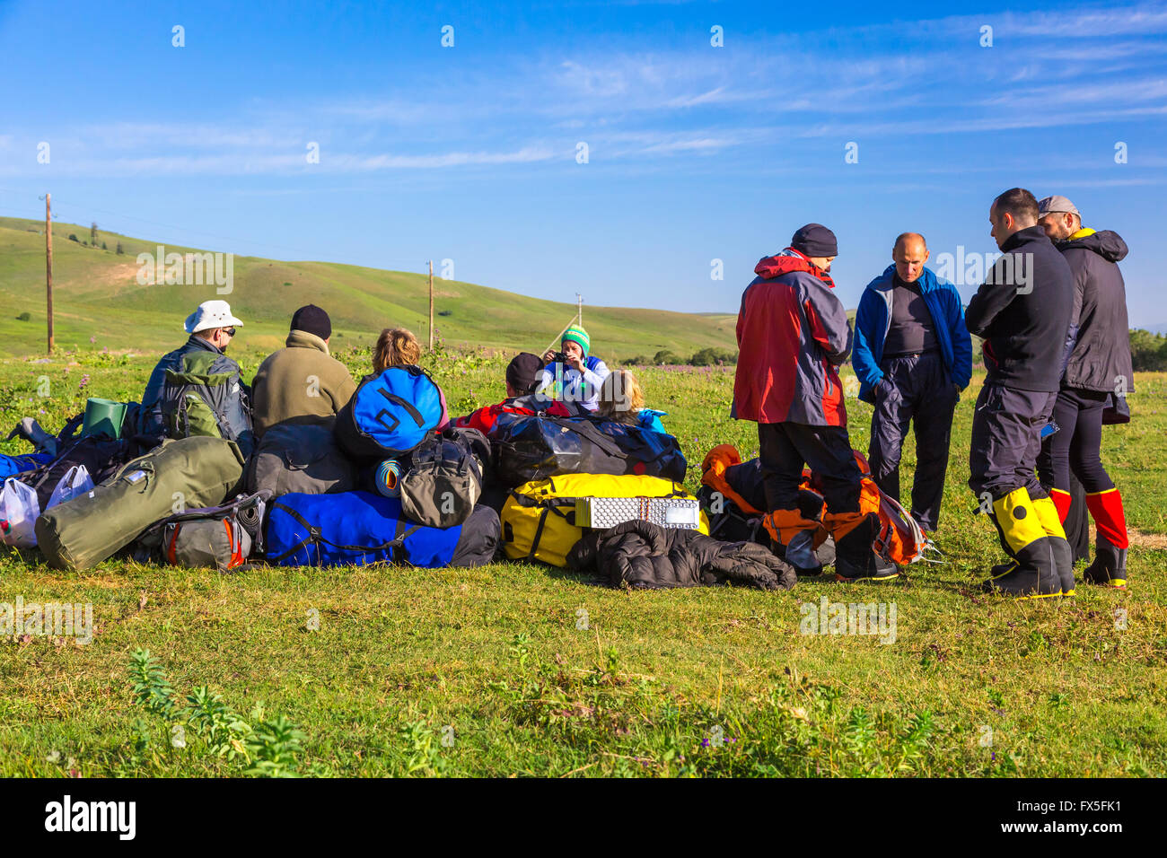 Group of People and Many Backpacks on Grassy Lawn Stock Photo - Alamy