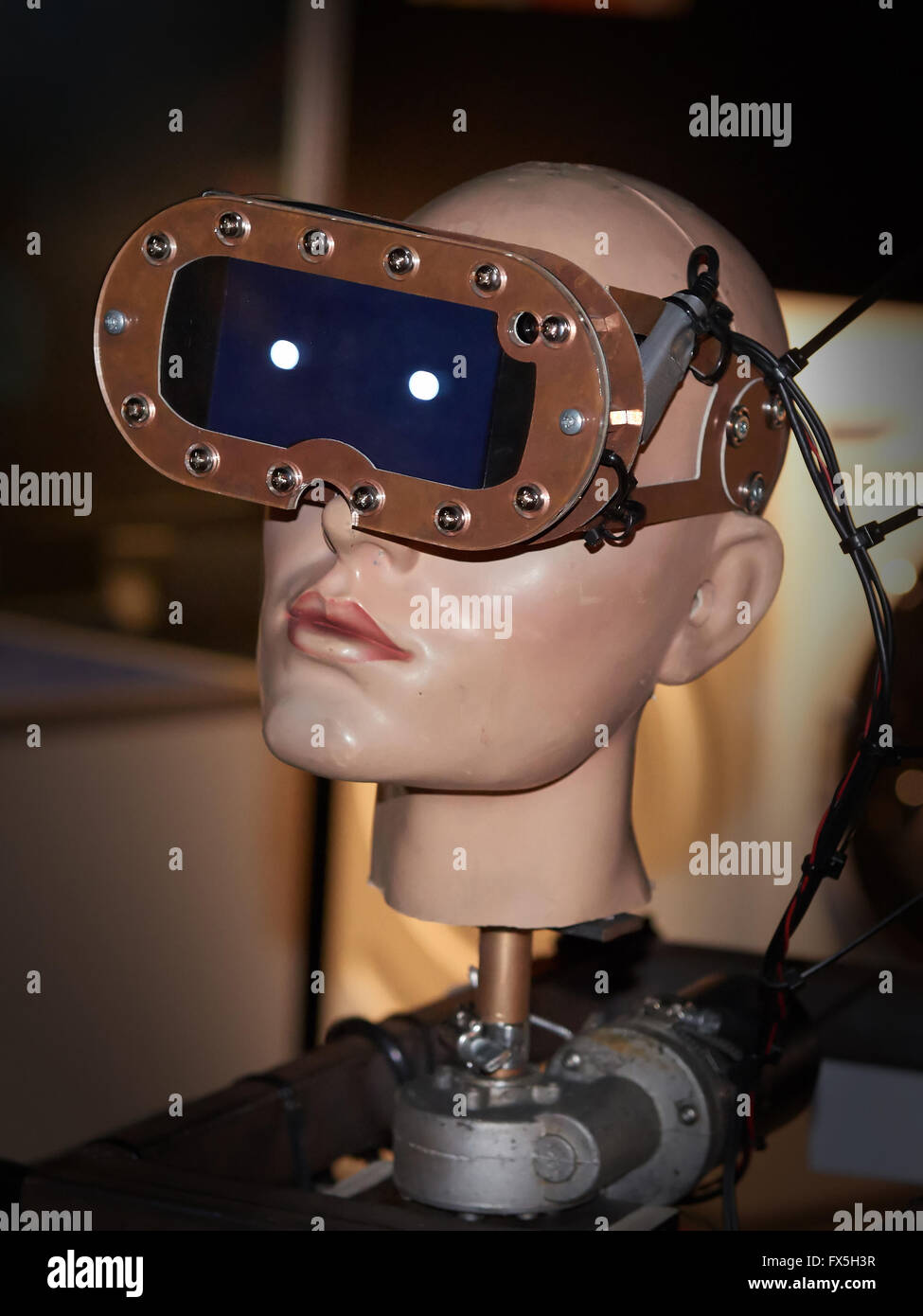 Closeup image of the face of a robot with electronic goggles for eyes ...