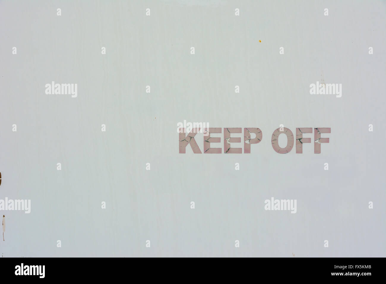 Keep Off hand painted sign against a plain white metal background Stock ...