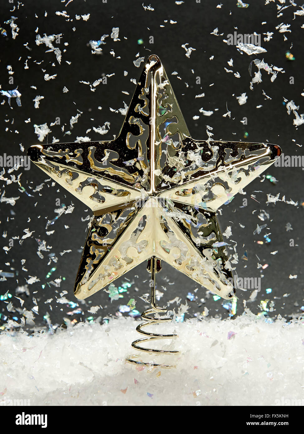 Golden christmas star with falling snow Stock Photo - Alamy