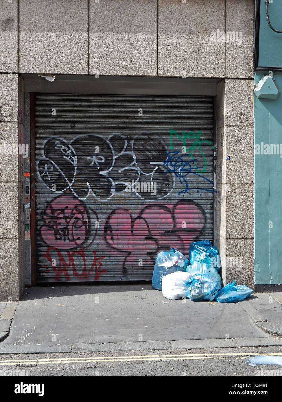 Garbage and graffiti on a metal gate in london, England Stock Photo - Alamy
