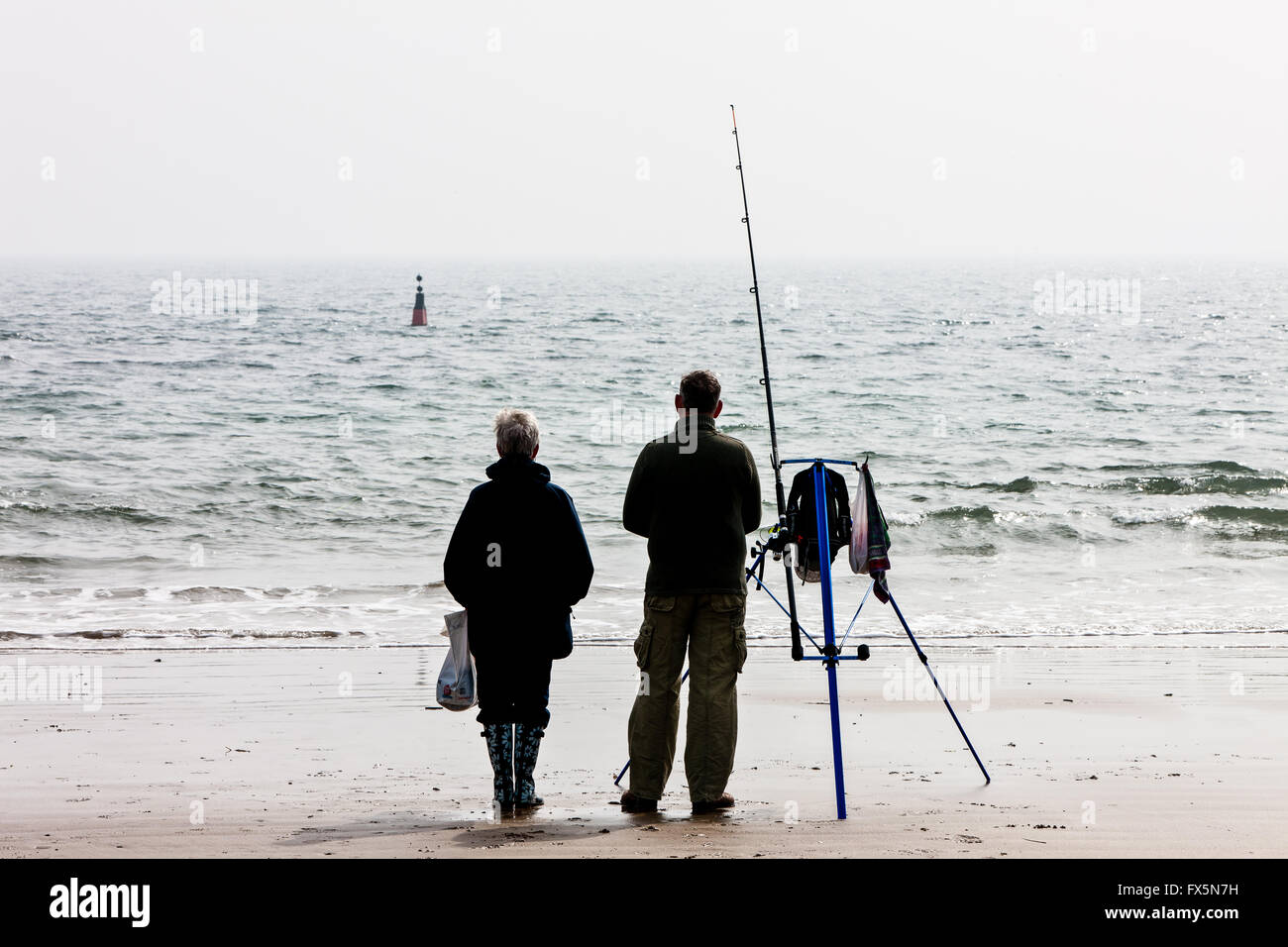 Fisherman /angler along South Beach along Pembrokeshire Coast Path in ...