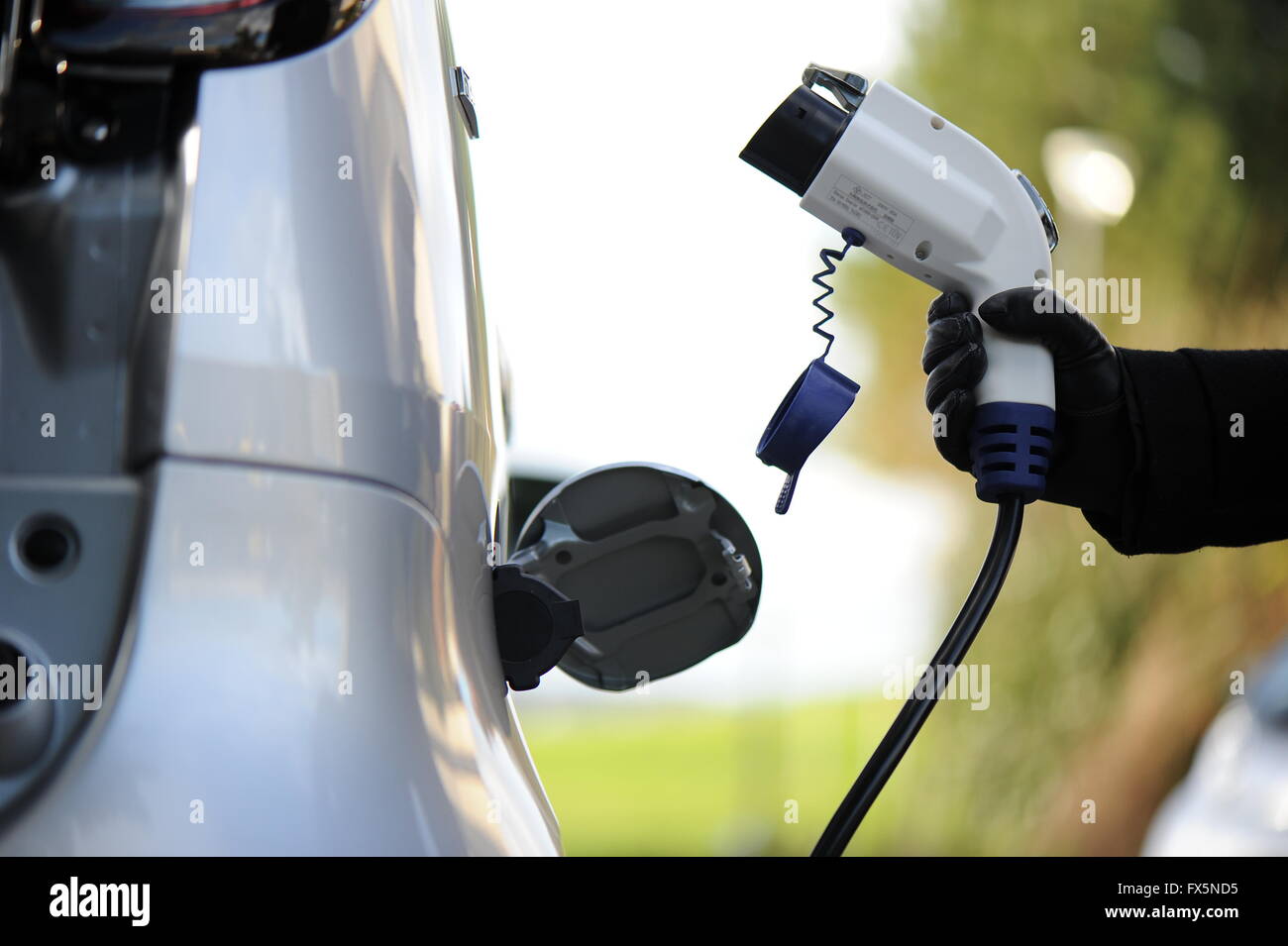 Electric car charging plug eco friendly Stock Photo - Alamy