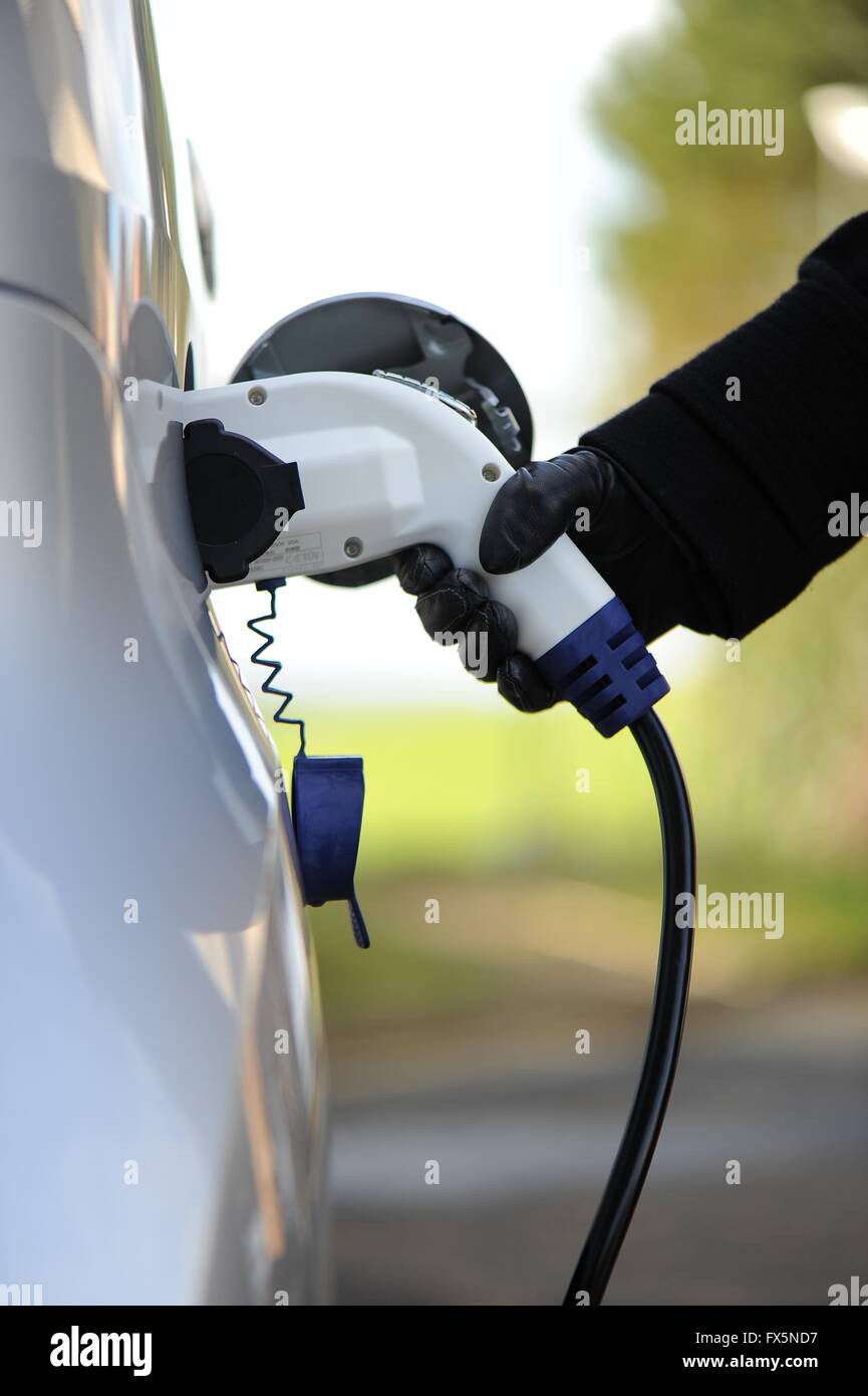 Electric car charging plug eco friendly Stock Photo - Alamy