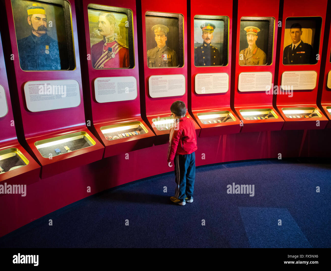A boy looks at the portraits and medals of the recipients of the ...