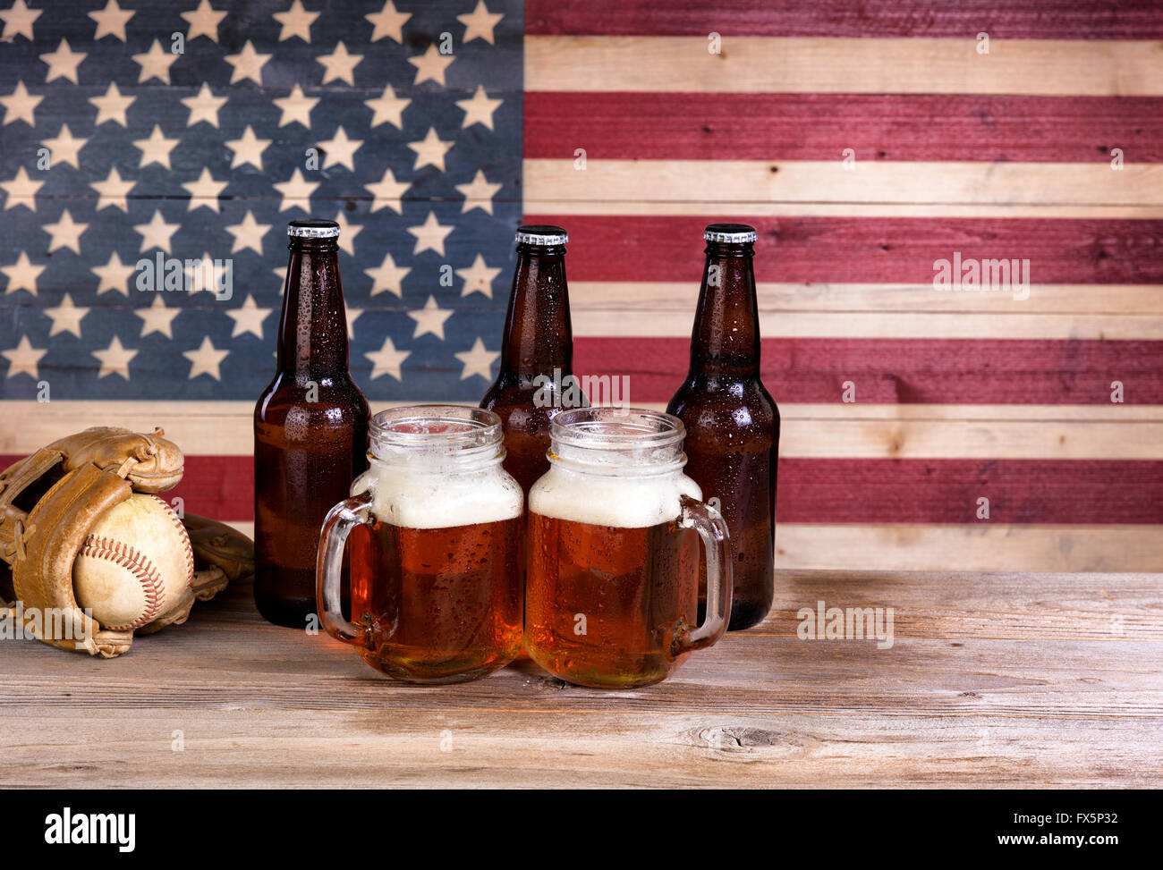 Two pint jars filled with beer, full bottles and baseball mitt with ...
