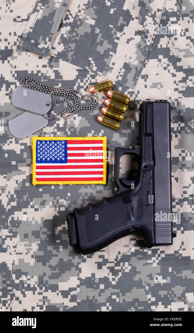 USA flag patch, ID tags, pistol, bullets on military battle dress ...