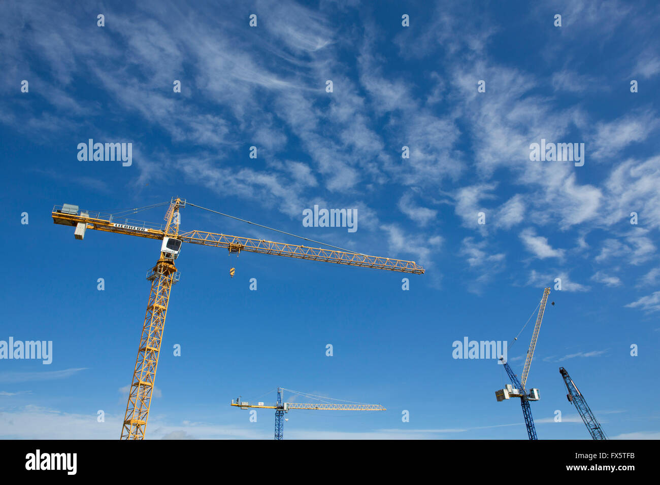 The top of tall crane arms showing the hook and lifting arm on a ...